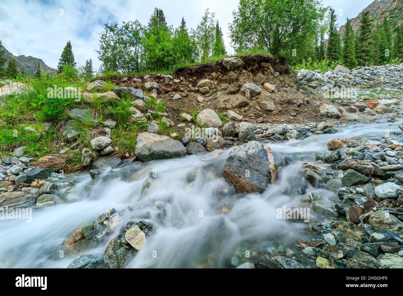 Clean spring water flowing down from the mountain Stock Photo - Alamy