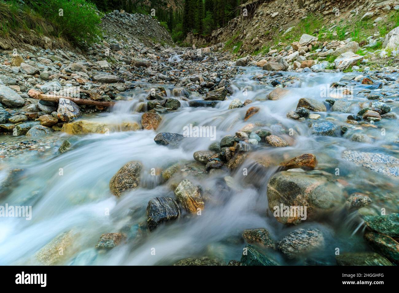 Clean spring water flowing down from the mountain Stock Photo - Alamy