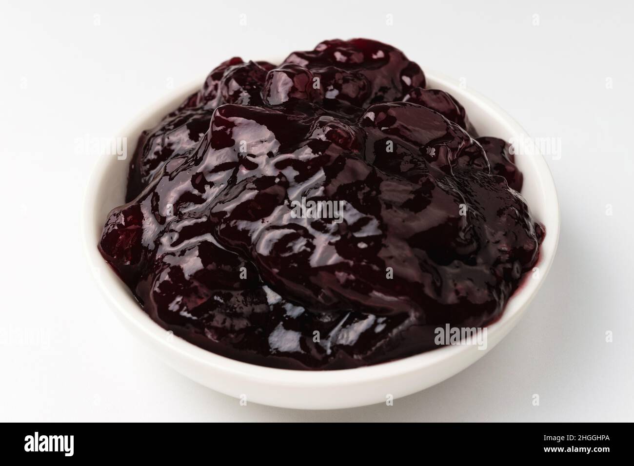 Grape jam on a white background Stock Photo - Alamy