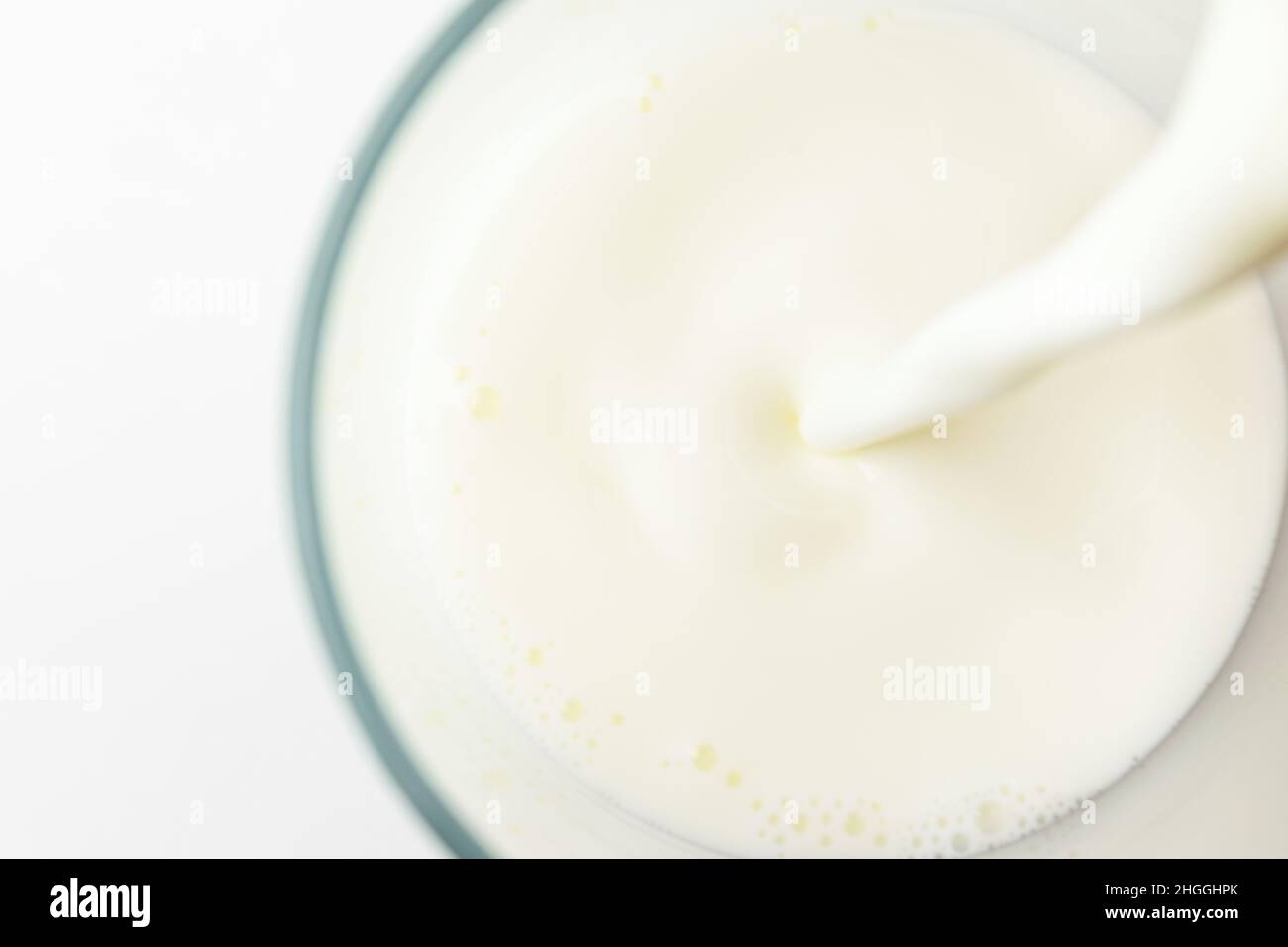 White milk on white background Stock Photo - Alamy
