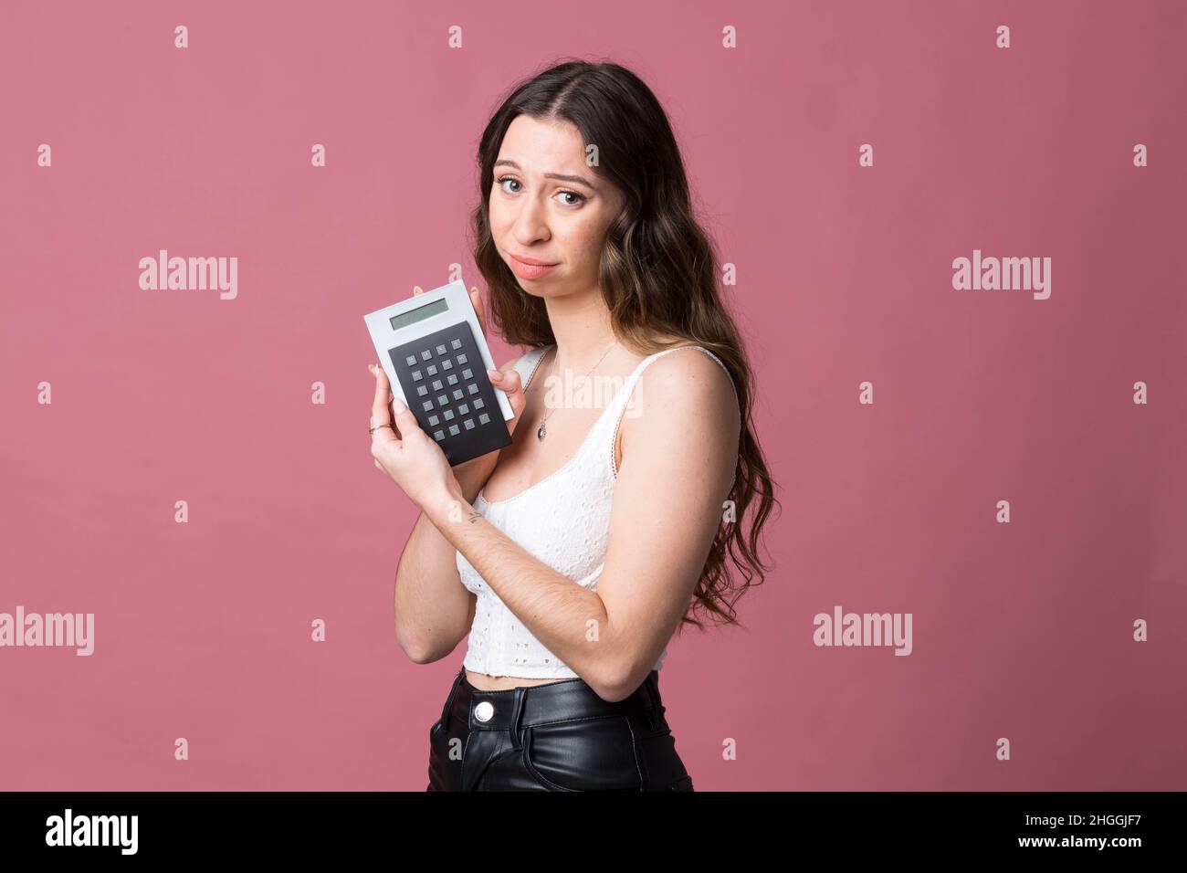 young girl with a calculator in her hand Stock Photo - Alamy