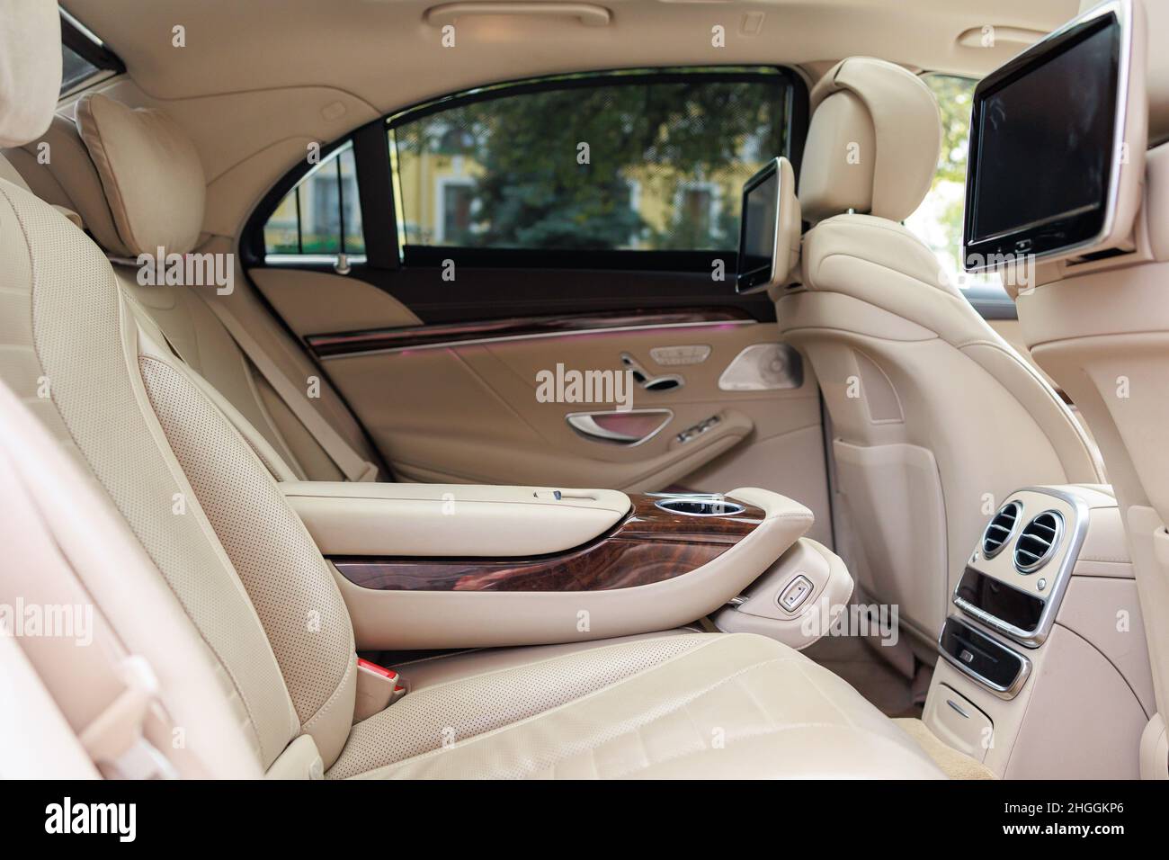 The rear seats of the luxury car in real wood and leather and the ...