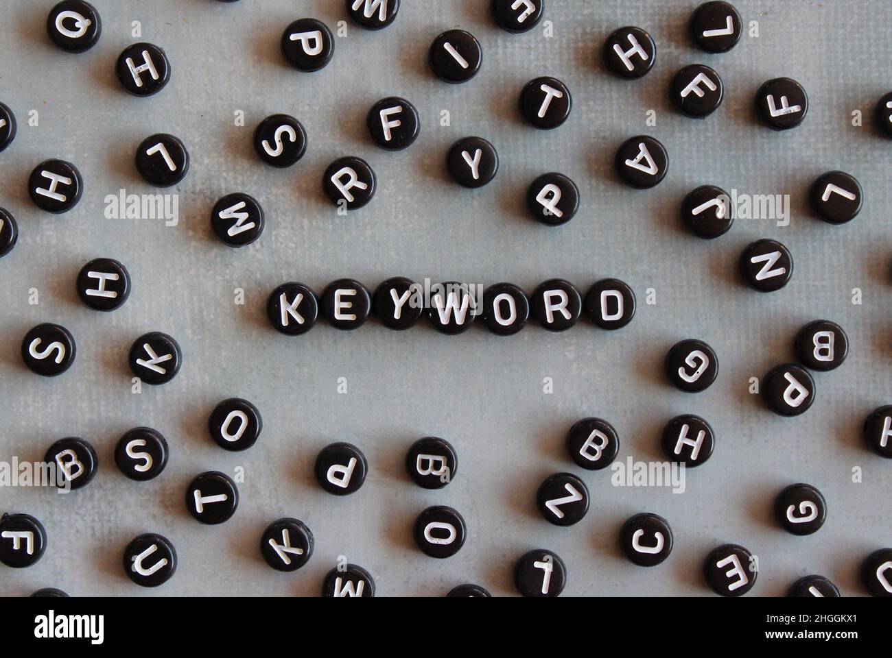 Alphabet beads with text KEYWORD on concrete floor Stock Photo - Alamy