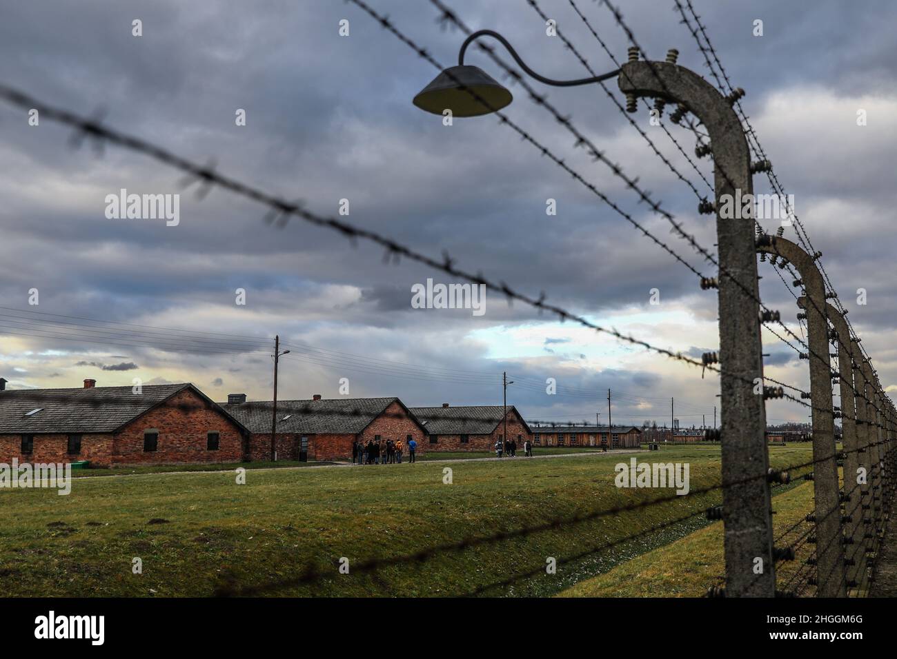Barbed wire fence and barracks at the former Nazi-German Auschwitz II ...