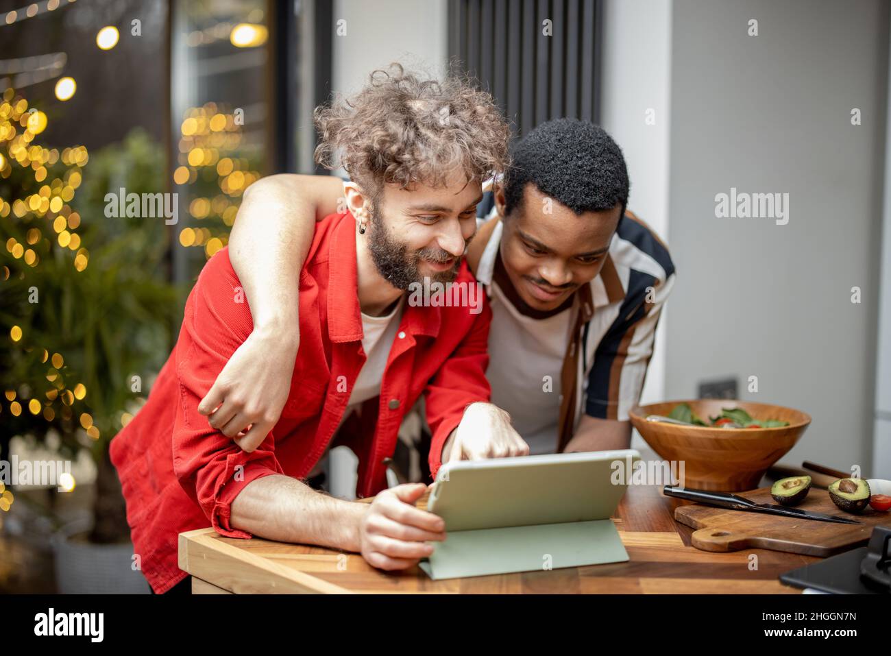 Two guys watching movie together on digital tablet at home Stock Photo ...