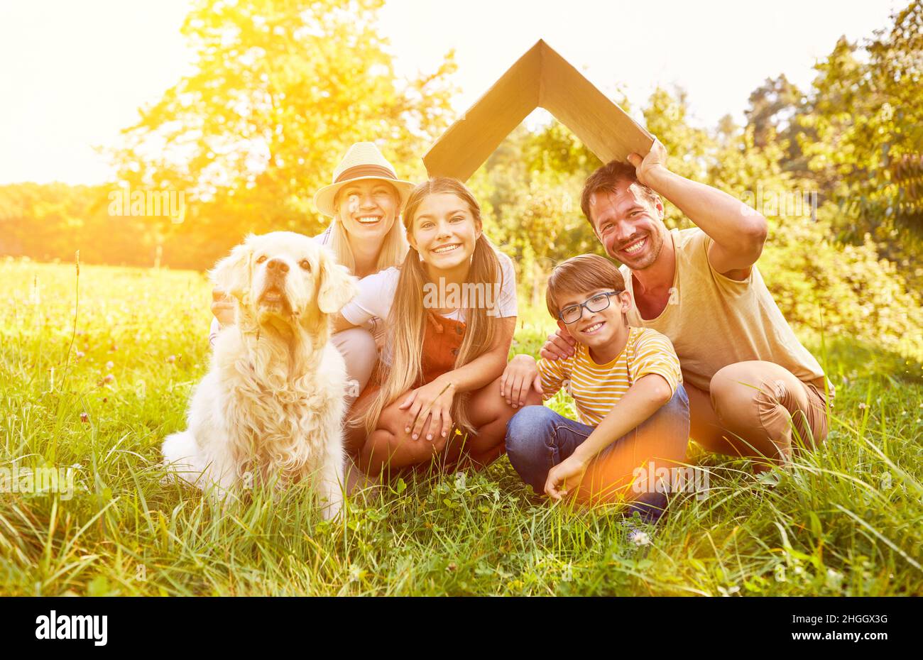 Happy family with two children and dog having house building concept in ...