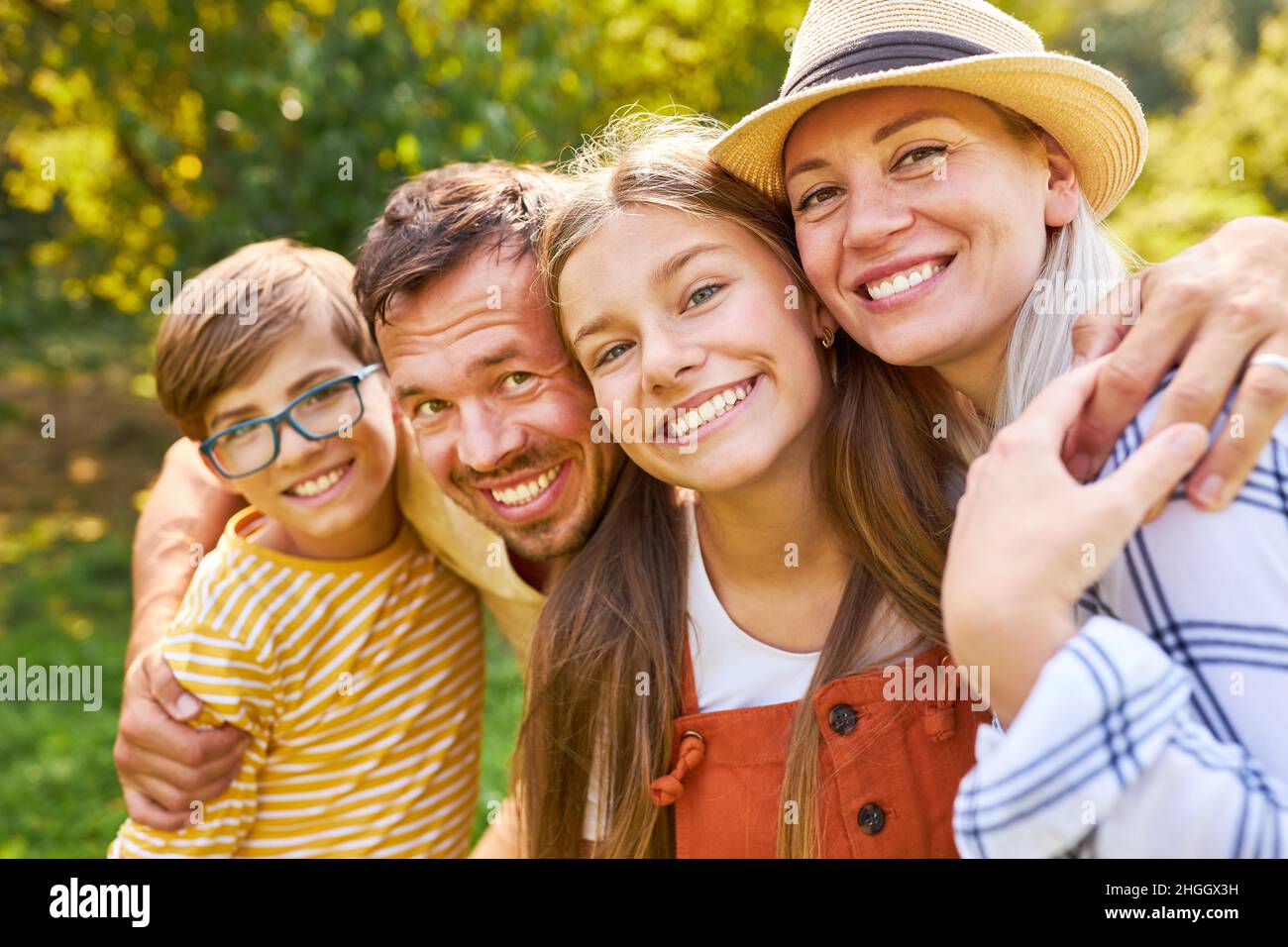 Happy family with two children stands hugging in park in nature in ...