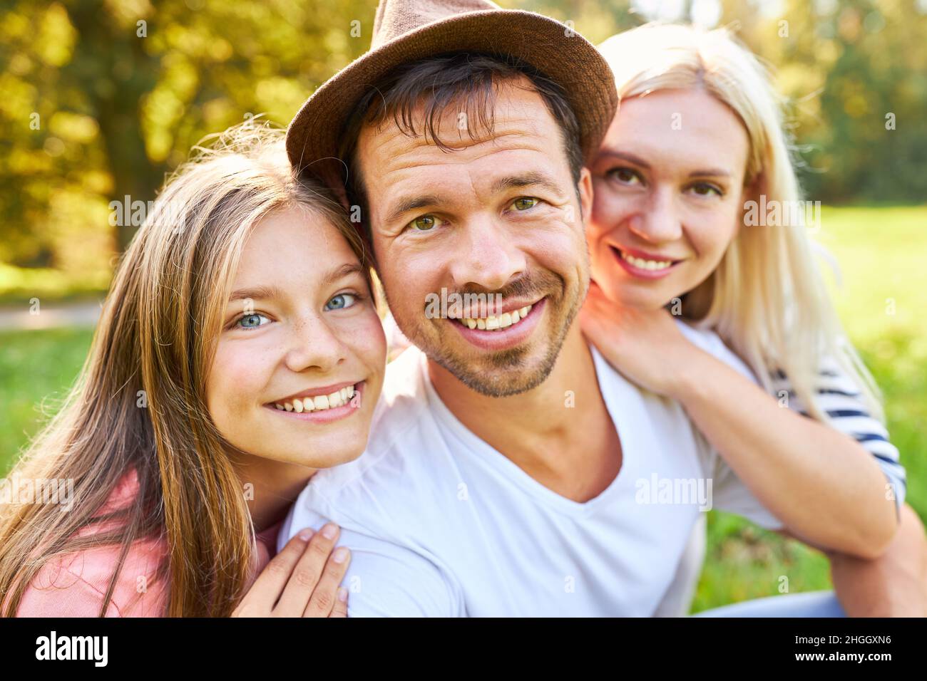 Happy parents together with their daughter on summer vacation in nature ...