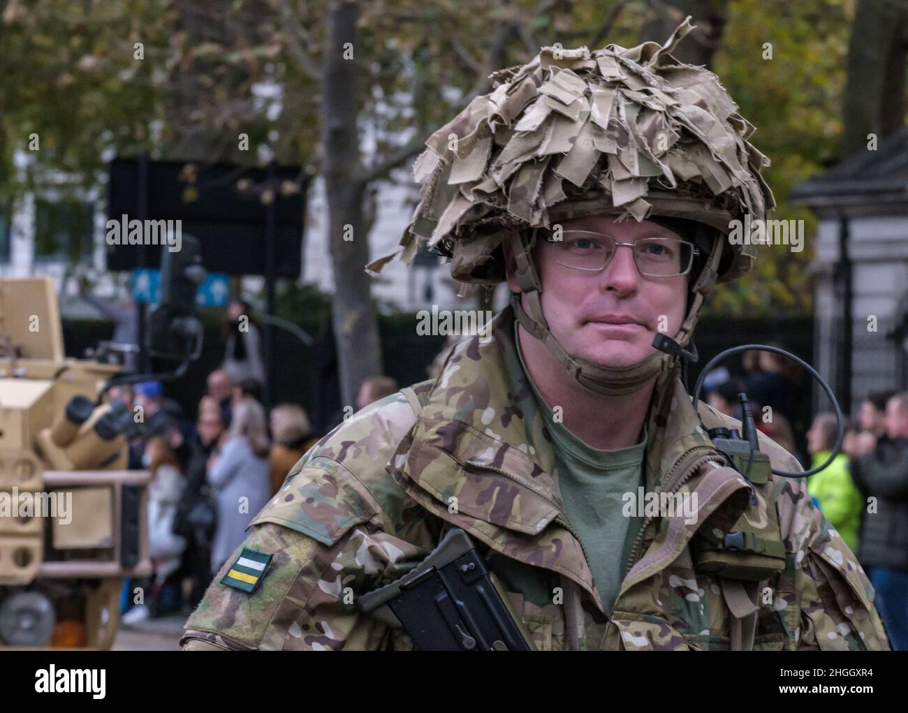 Closeup of man in combat gear & camouflage helmet marching with Royal ...