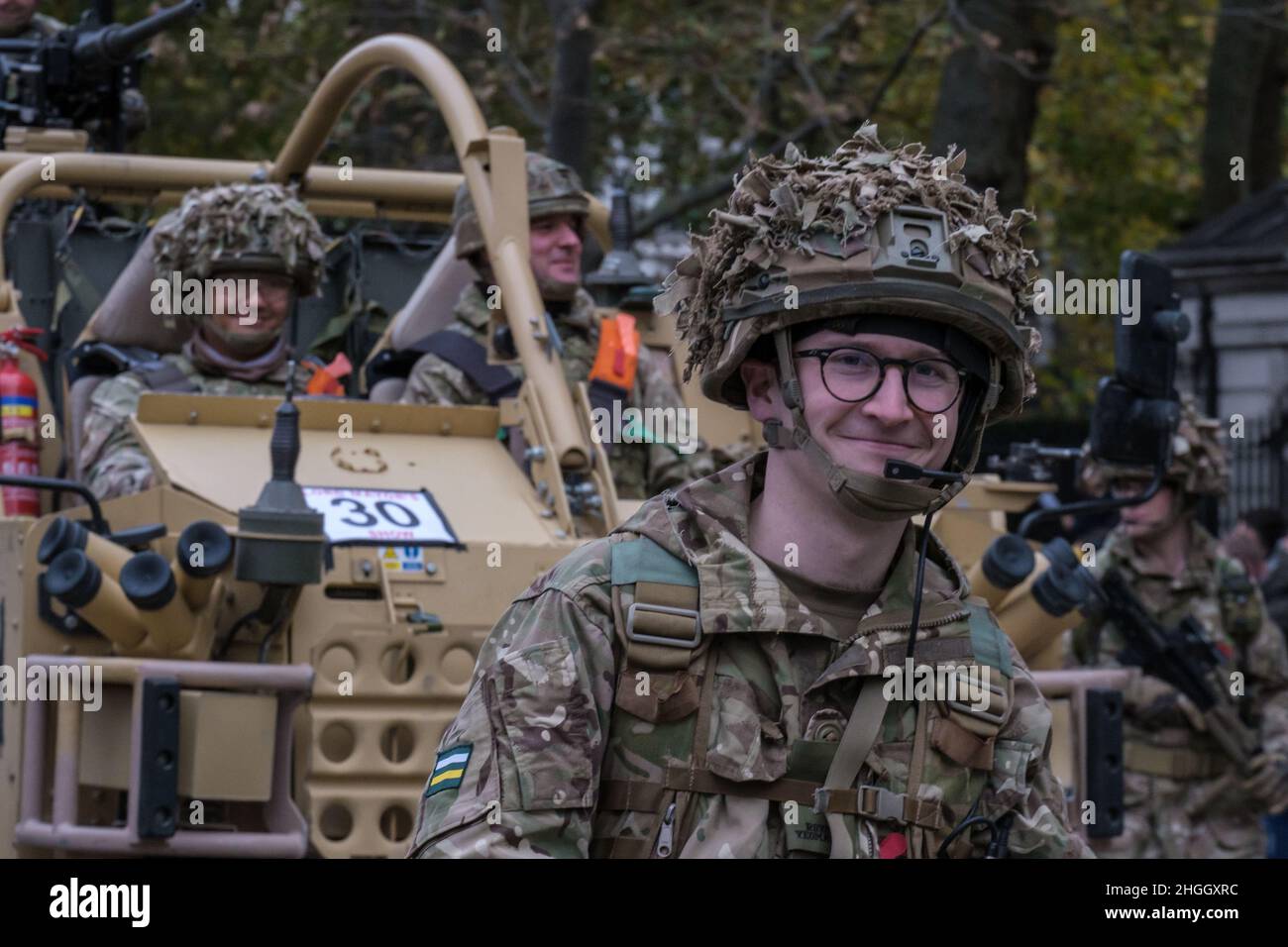 Closeup of man in combat gear & camouflage helmet marching with Royal ...