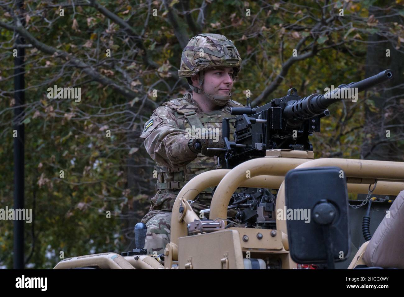 Man with combat rifle in combat gear rides on Jackal reconnaissance ...