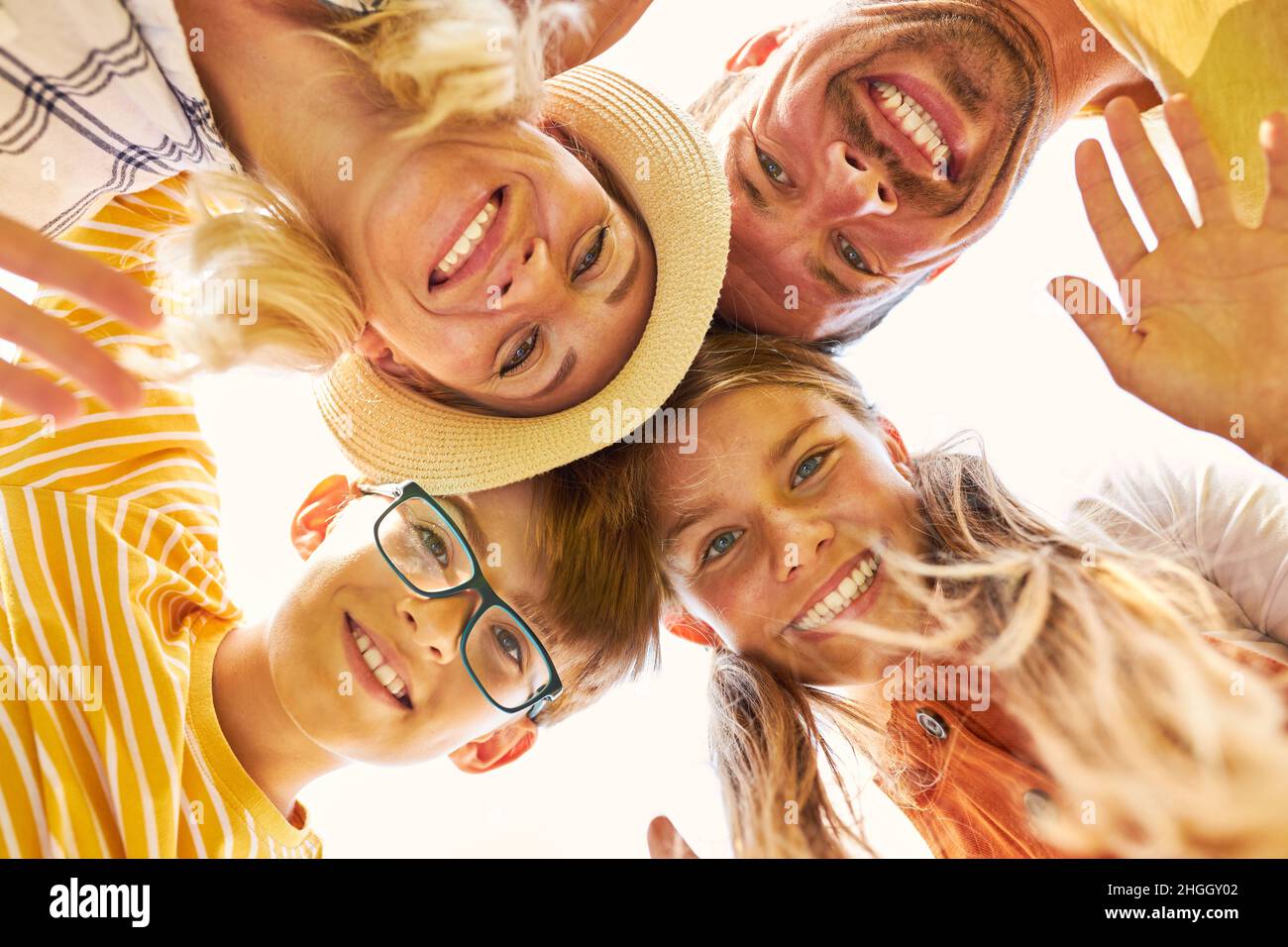 Parents with daughter and son laughing together in nature as happy ...