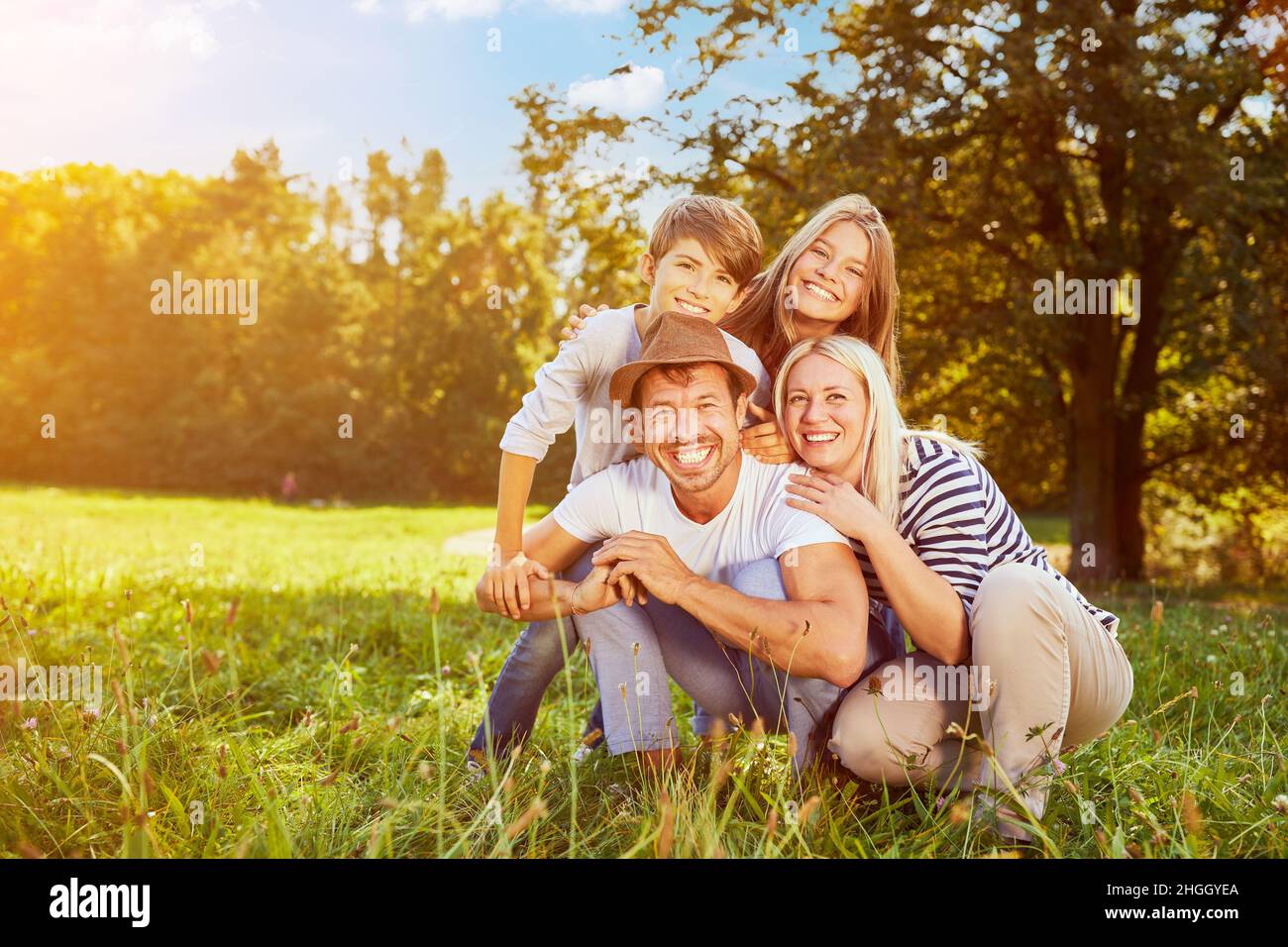 Happy family with two children on vacation in green nature in summer ...
