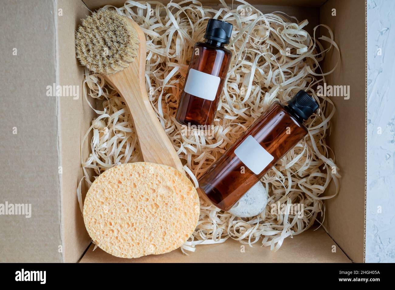 Beauty box with face and body care products on grey background. Bottles ...