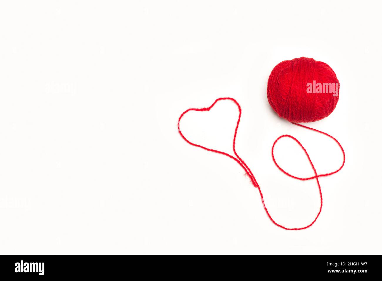 Red wool ball with a heart on a white background with copy space Stock ...