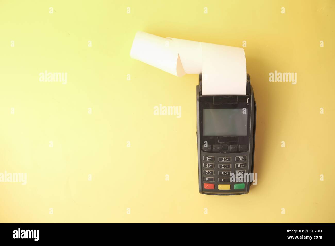 POS machine and long roll paper on blue Stock Photo - Alamy