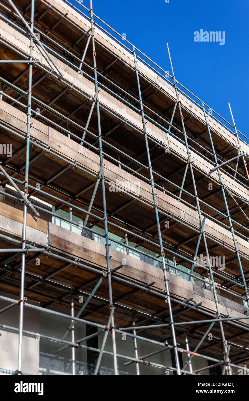 Metal scaffolding building frame with wooden boards platform on an ...