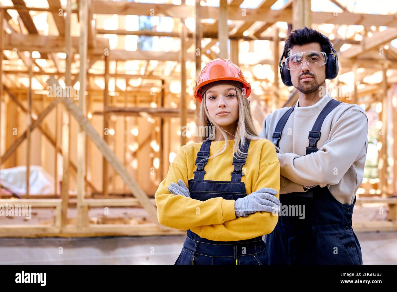 Portrait of serious male and female construction comrades posing at ...