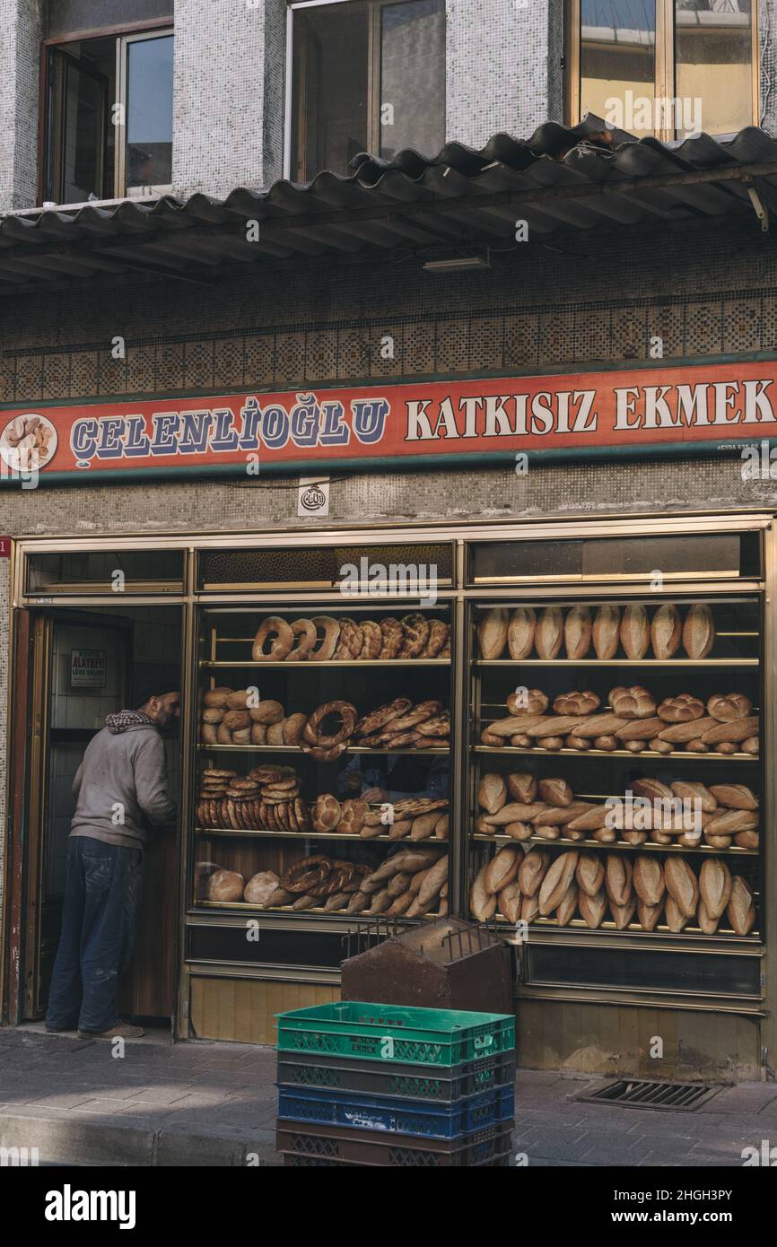 Bakery with a window shop full of turkish breads and a customer buying ...