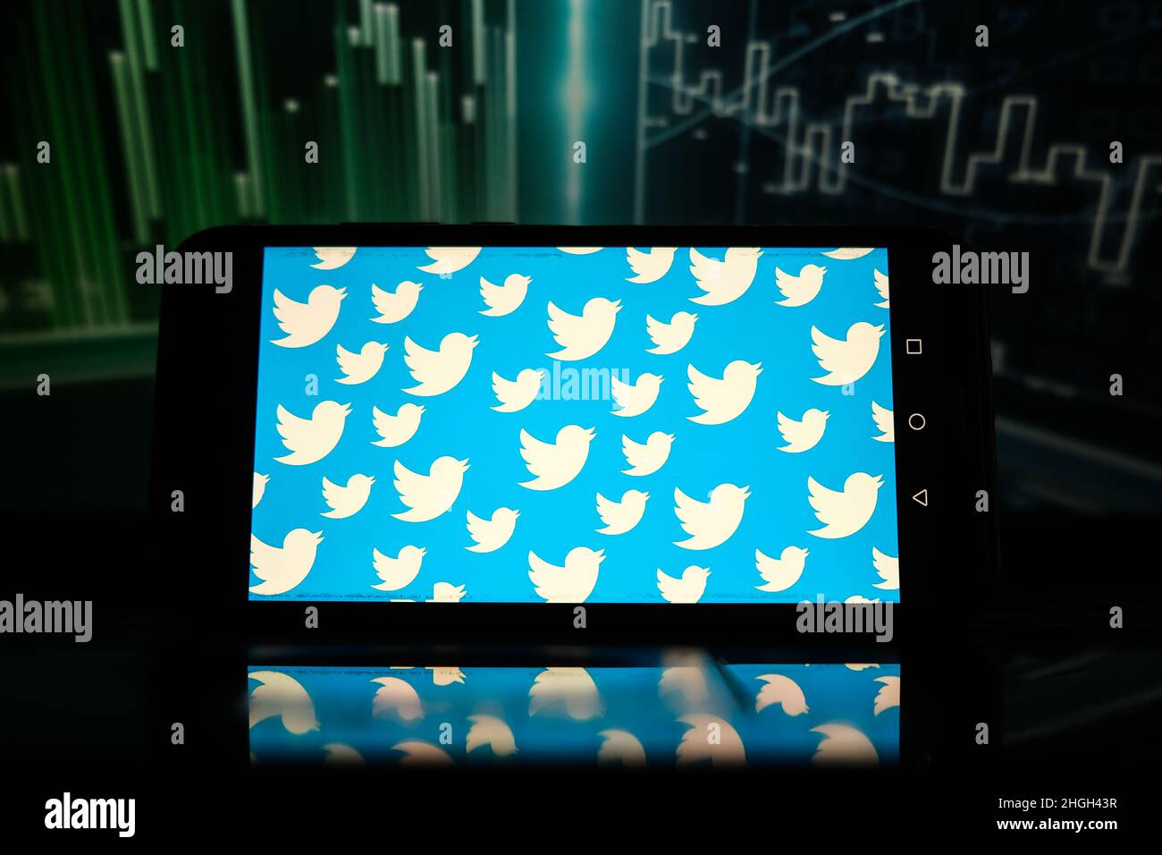 In this photo illustration, Twitter logos displayed on a smartphone ...