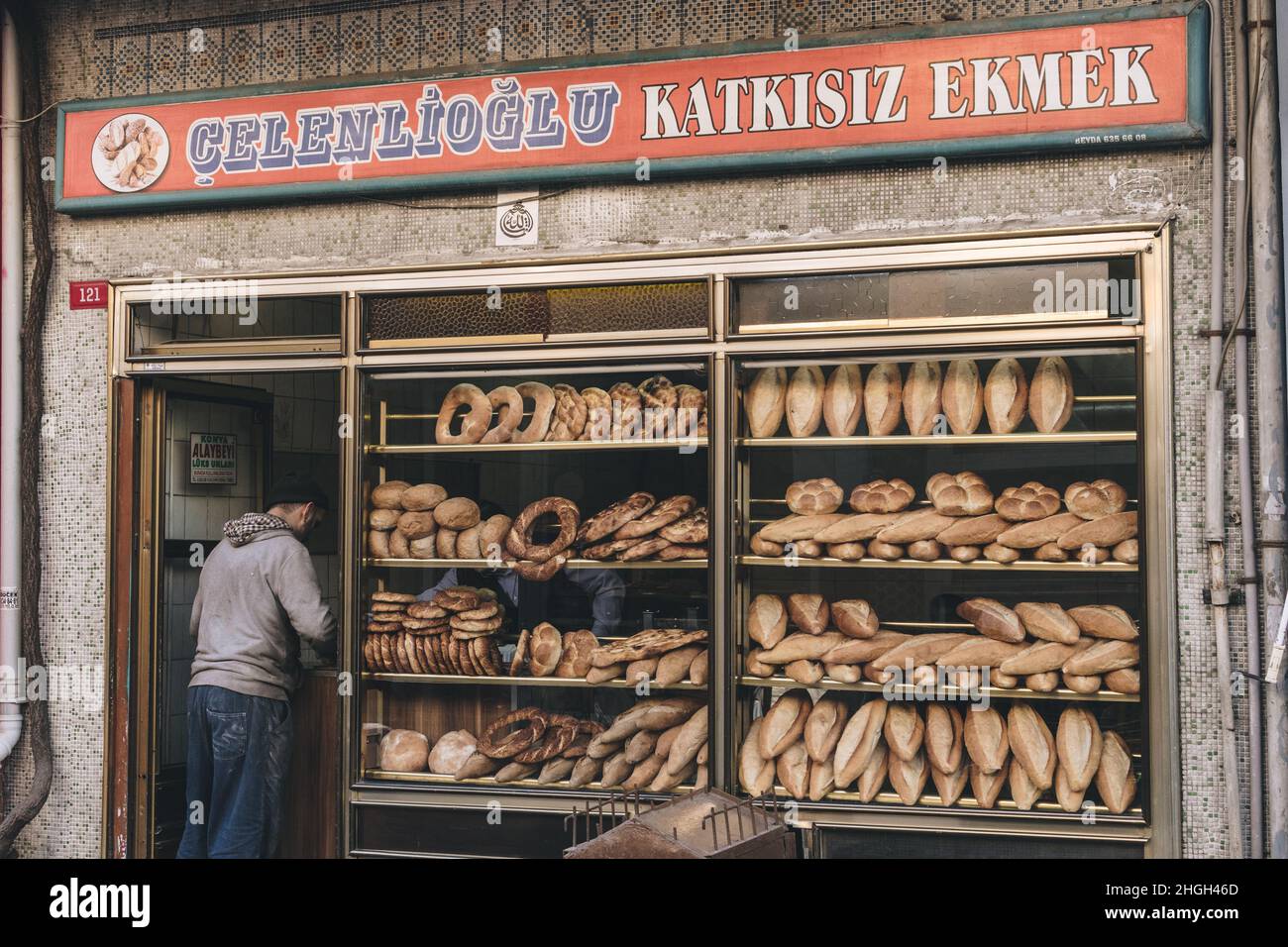 Bakery with a window shop full of turkish breads and a customer buying ...