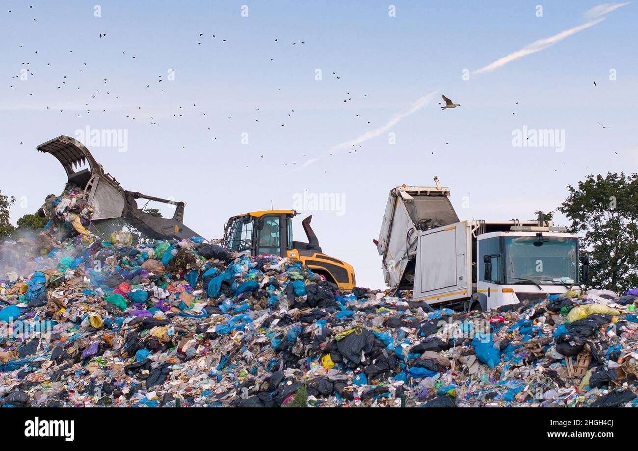 Landfill waste disposal. Garbage truck unloads rubbish in landfill ...