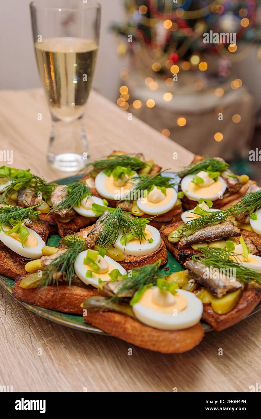 Toasted bread with sprats, eggs and herbs. Traditional Russian food for ...