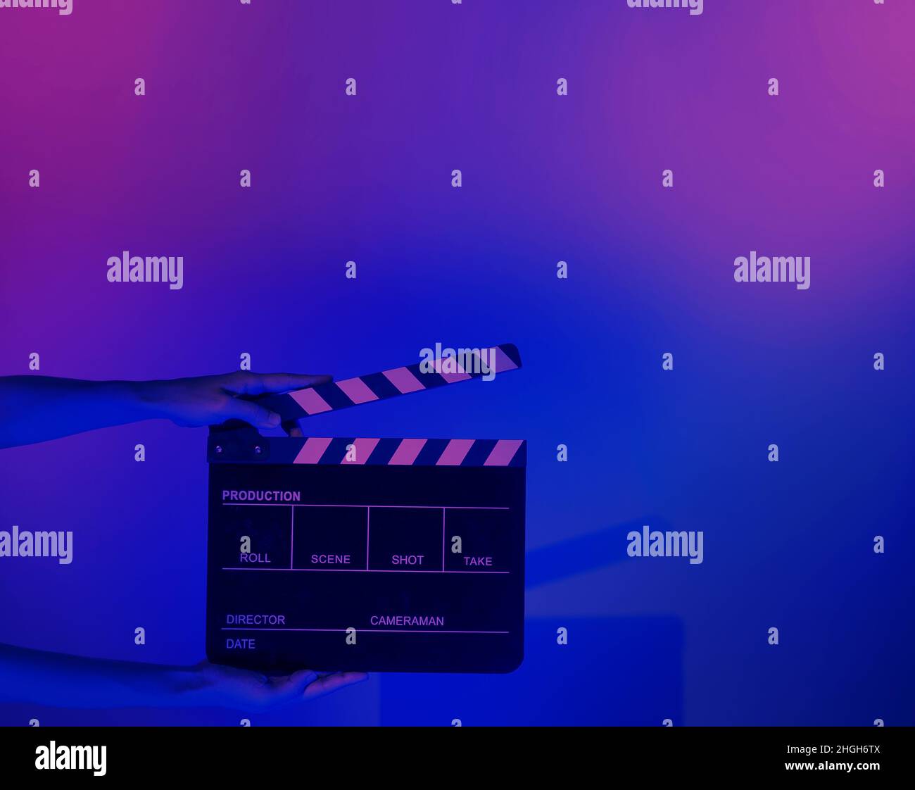 Blurry images of movie slate or clapper board. Hand holds empty film ...