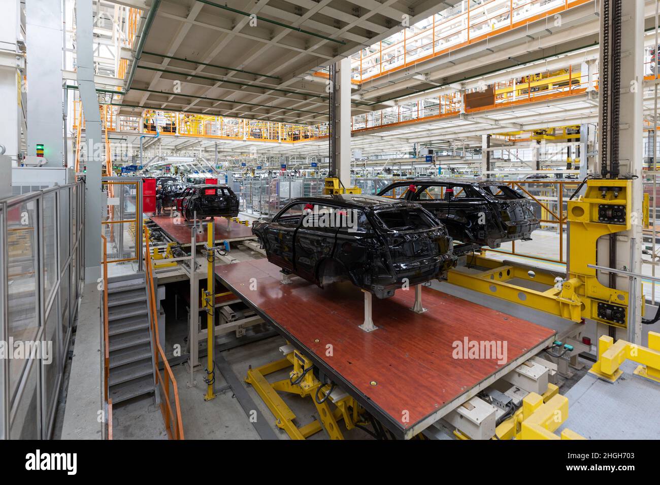 Car bodies are on assembly line. Factory for production of cars. Modern ...