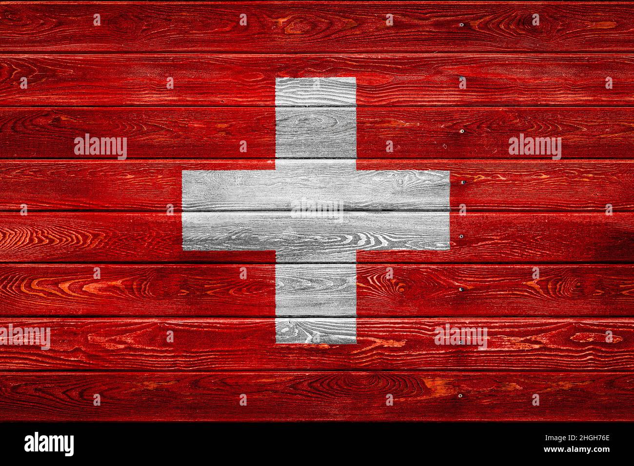 The national flag of Switzerland is painted on a camp of even boards ...