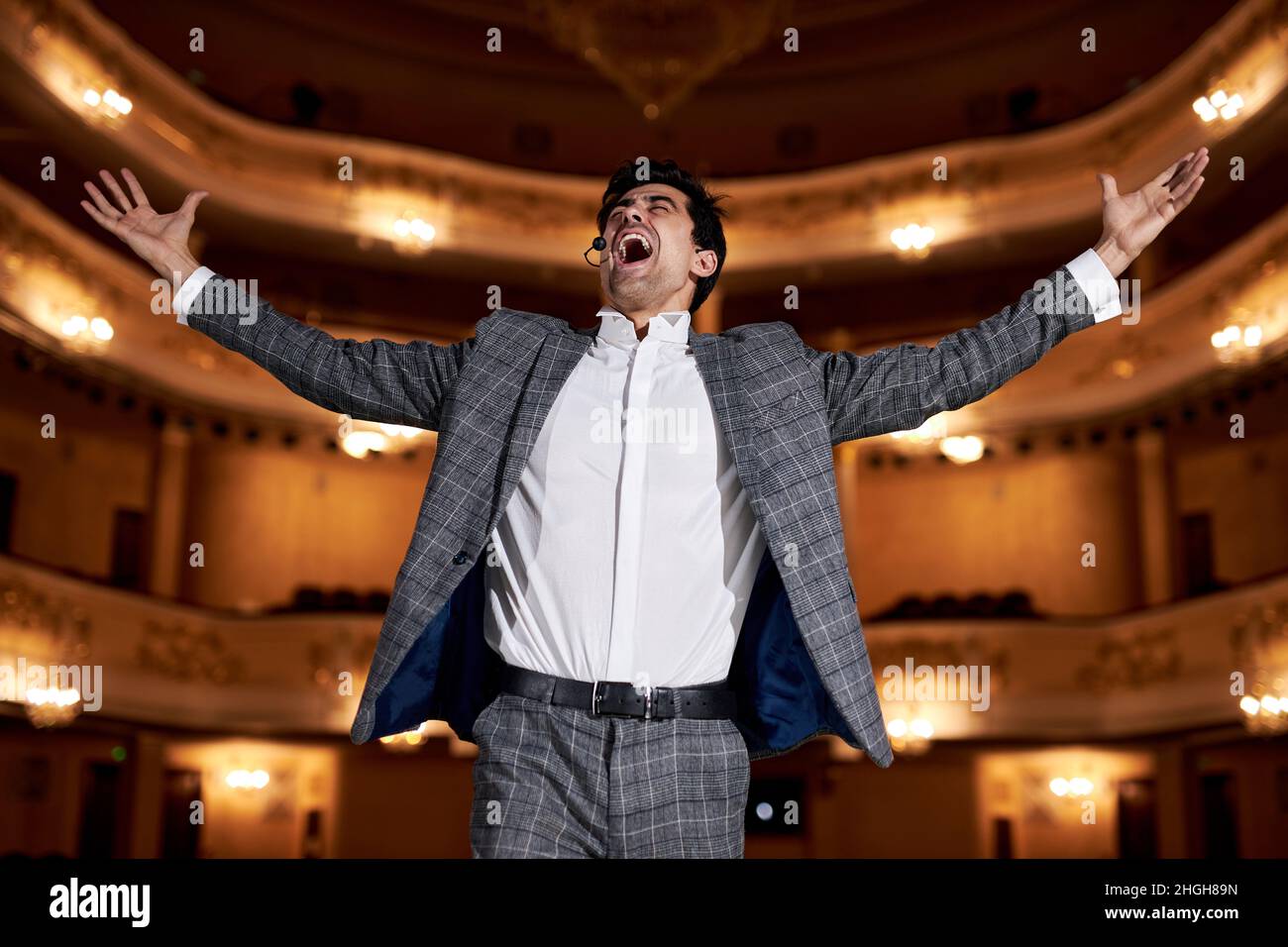 Portrait of handsome caucasian attractive singer in elegant gray ...