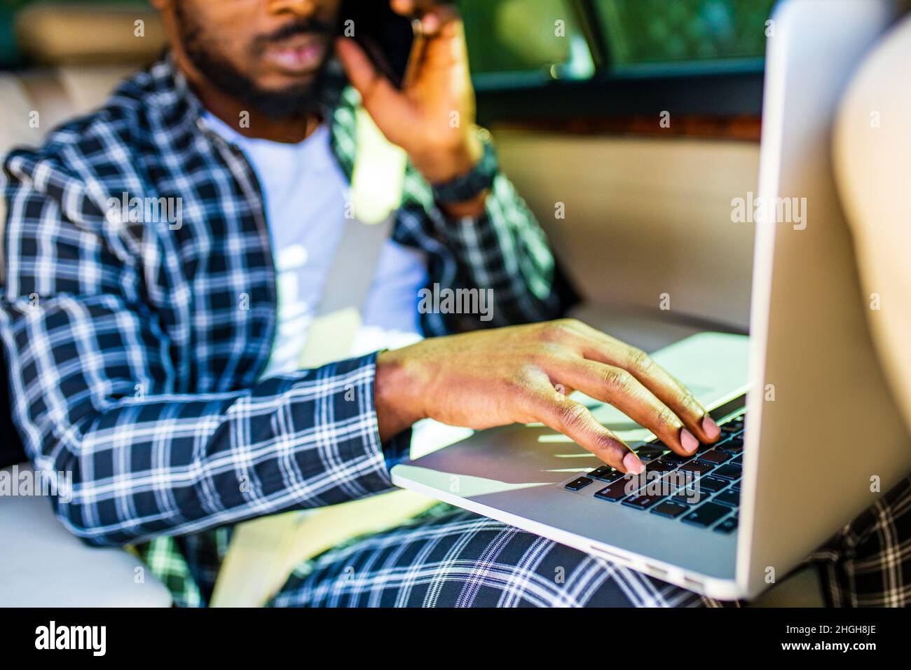 african american businessman making phone call while sitting on seat of ...