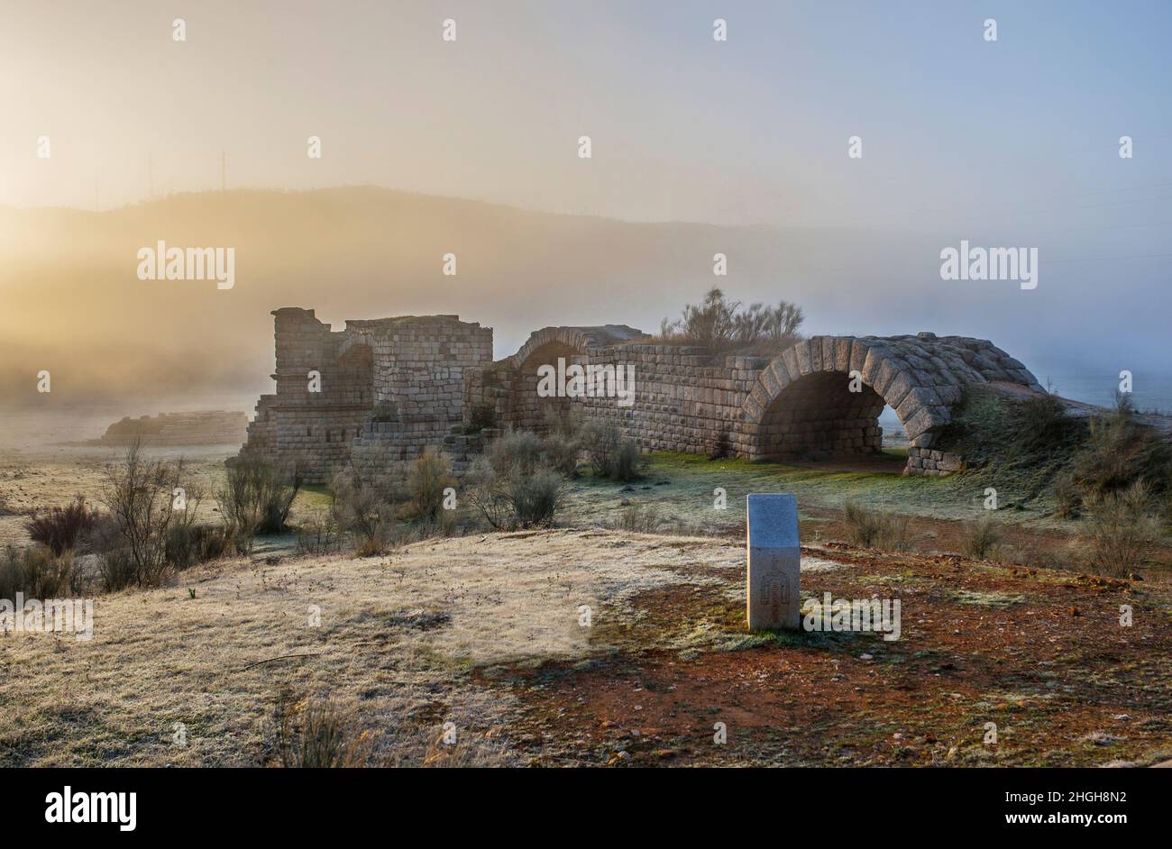 Alconetar Bridge remanis a fog winter rising, Caceres, Spain. Segmental ...