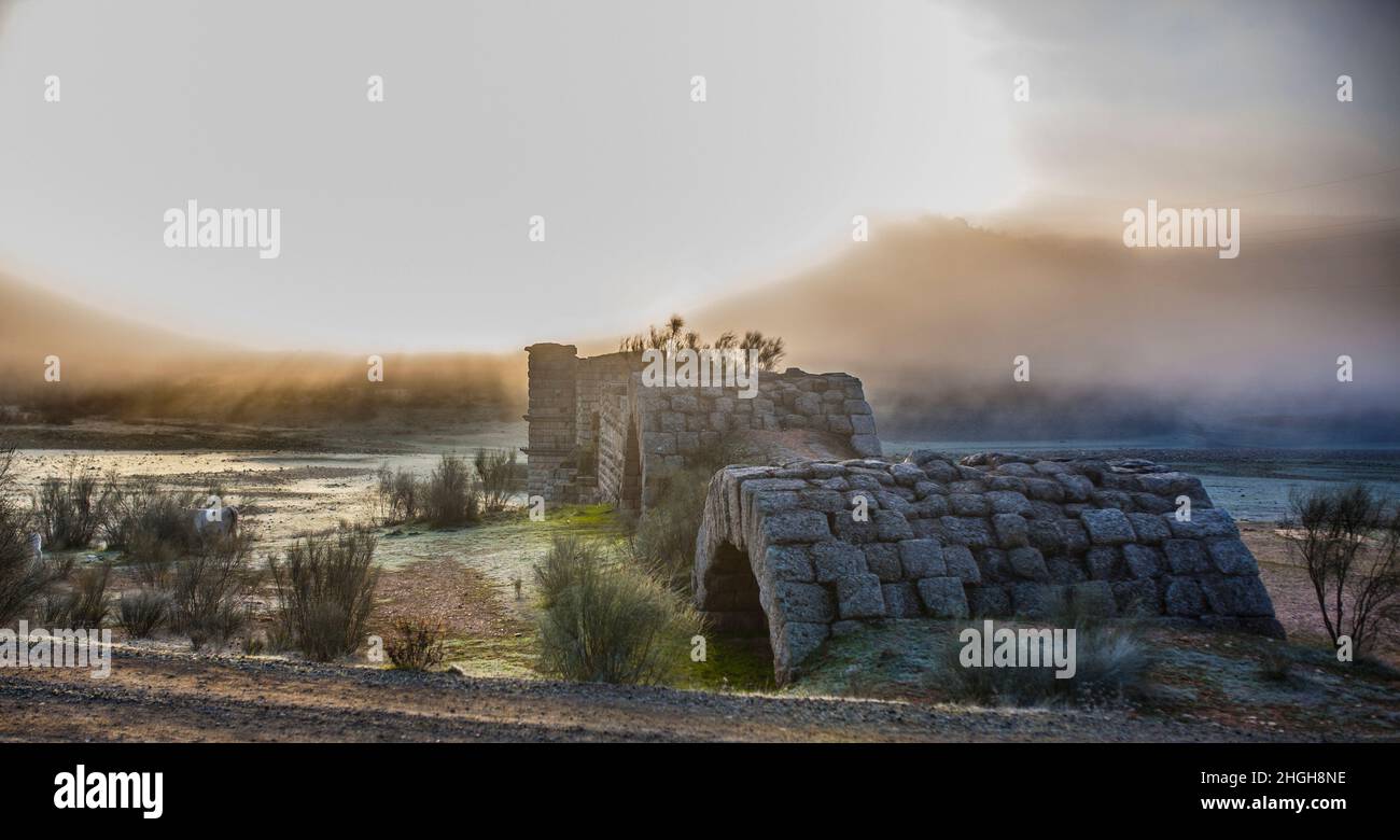 Alconetar Bridge remanis a fog winter rising, Caceres, Spain. Segmental ...