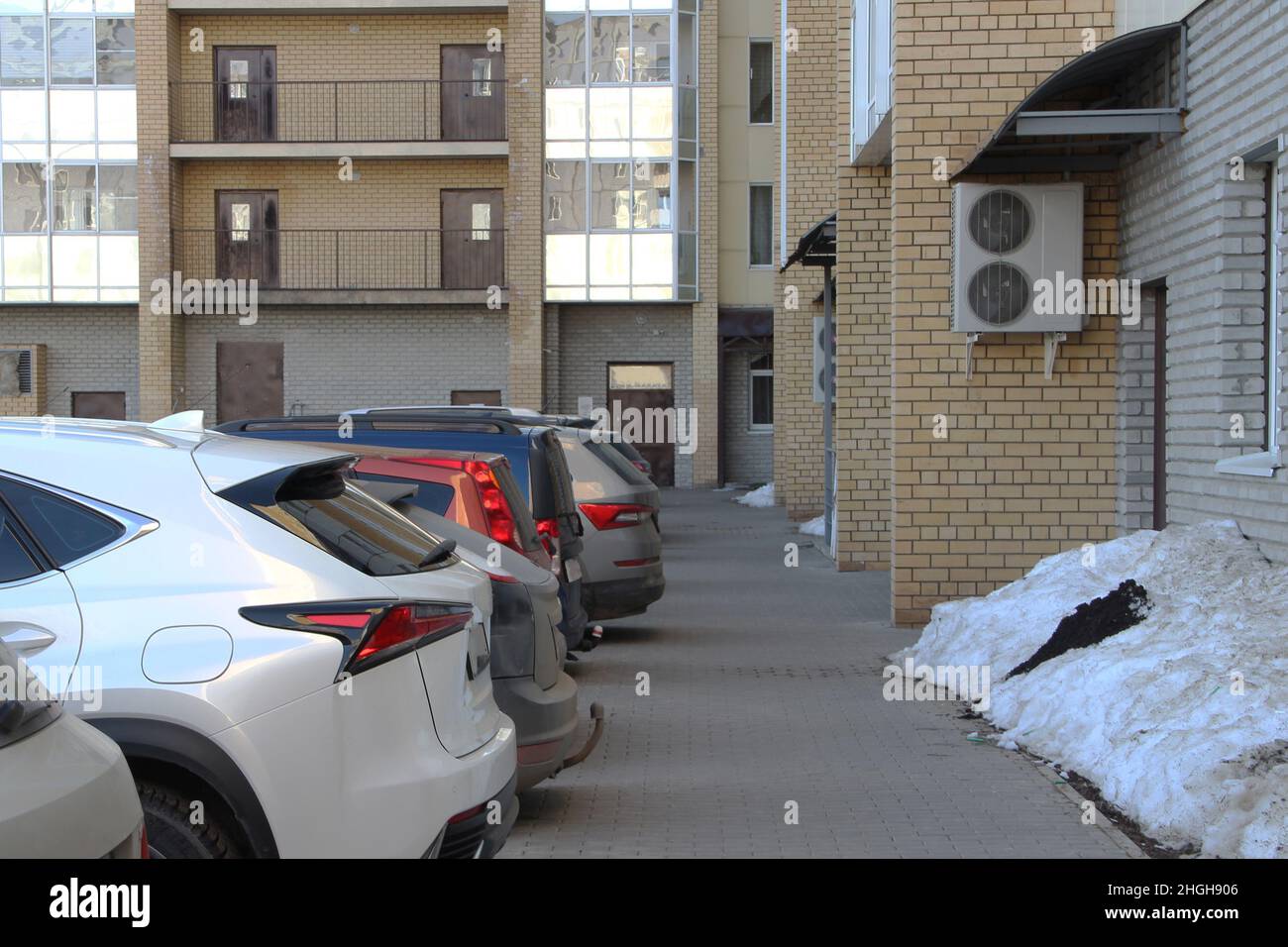 Row of cars parked near the house. The concept of parking spaces for ...