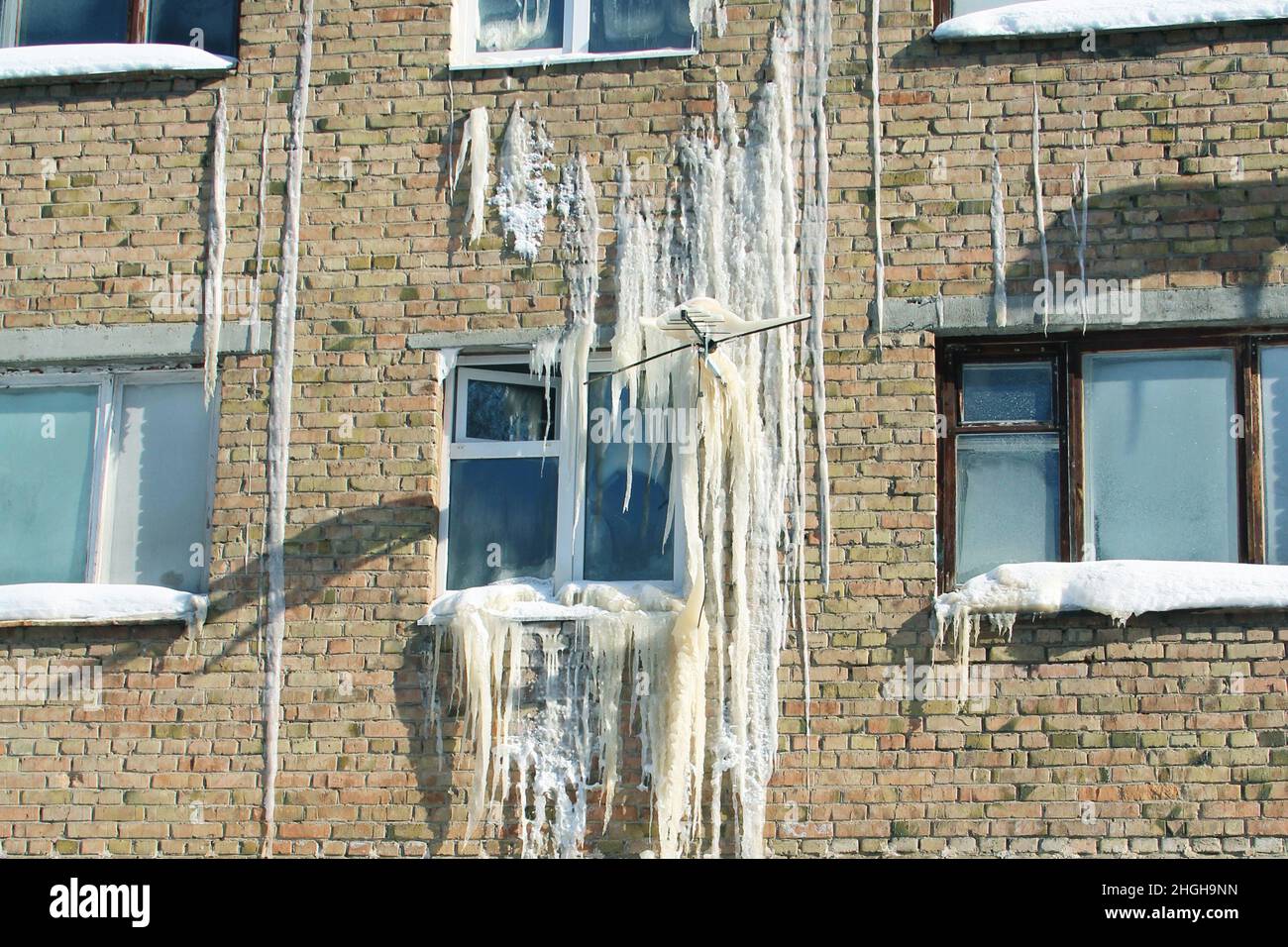 Iced wall of a brick house, emergency situation. Severe weather ...