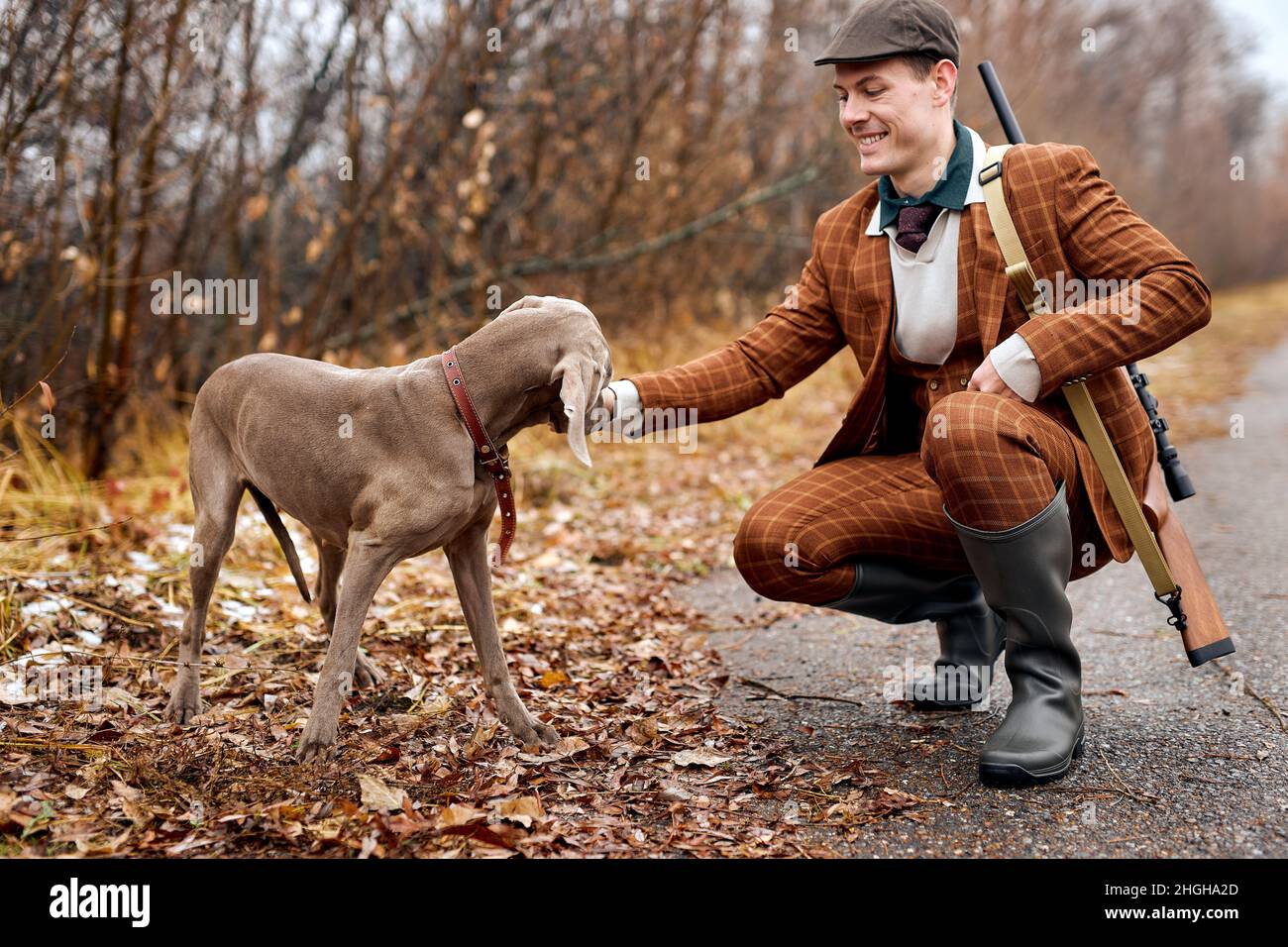 european man with pet dog going to hunt together in wild nature in ...