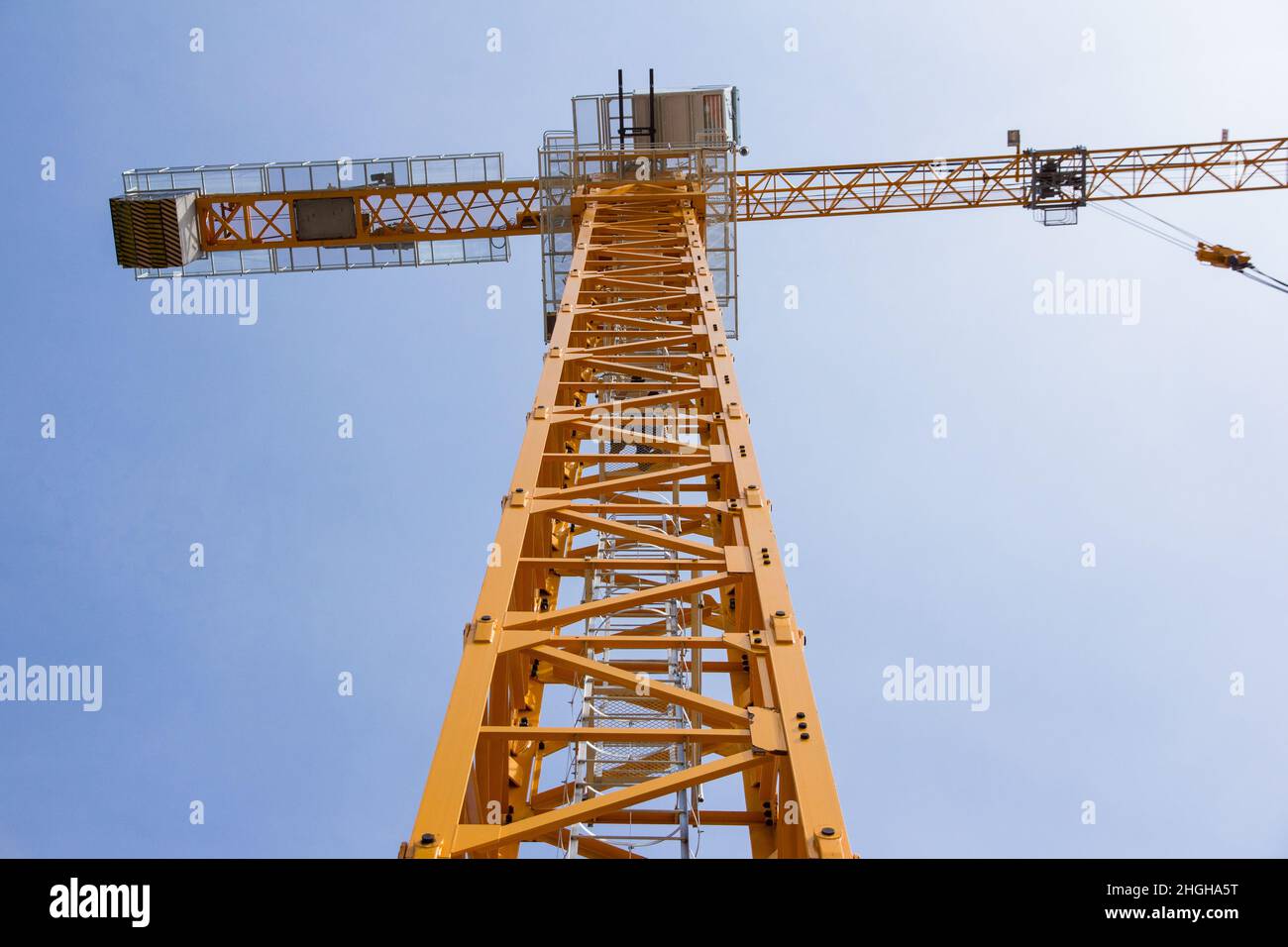 Big construction crane on blue sky background. Construction mechanism ...