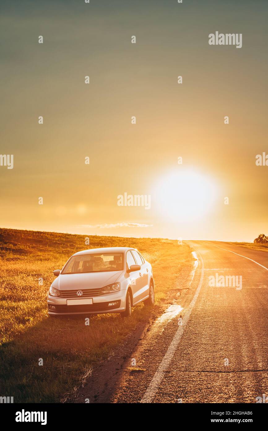 Sun Rising Over VW Volkswagen Polo Vento Sedan Car Parking Near Asphalt ...