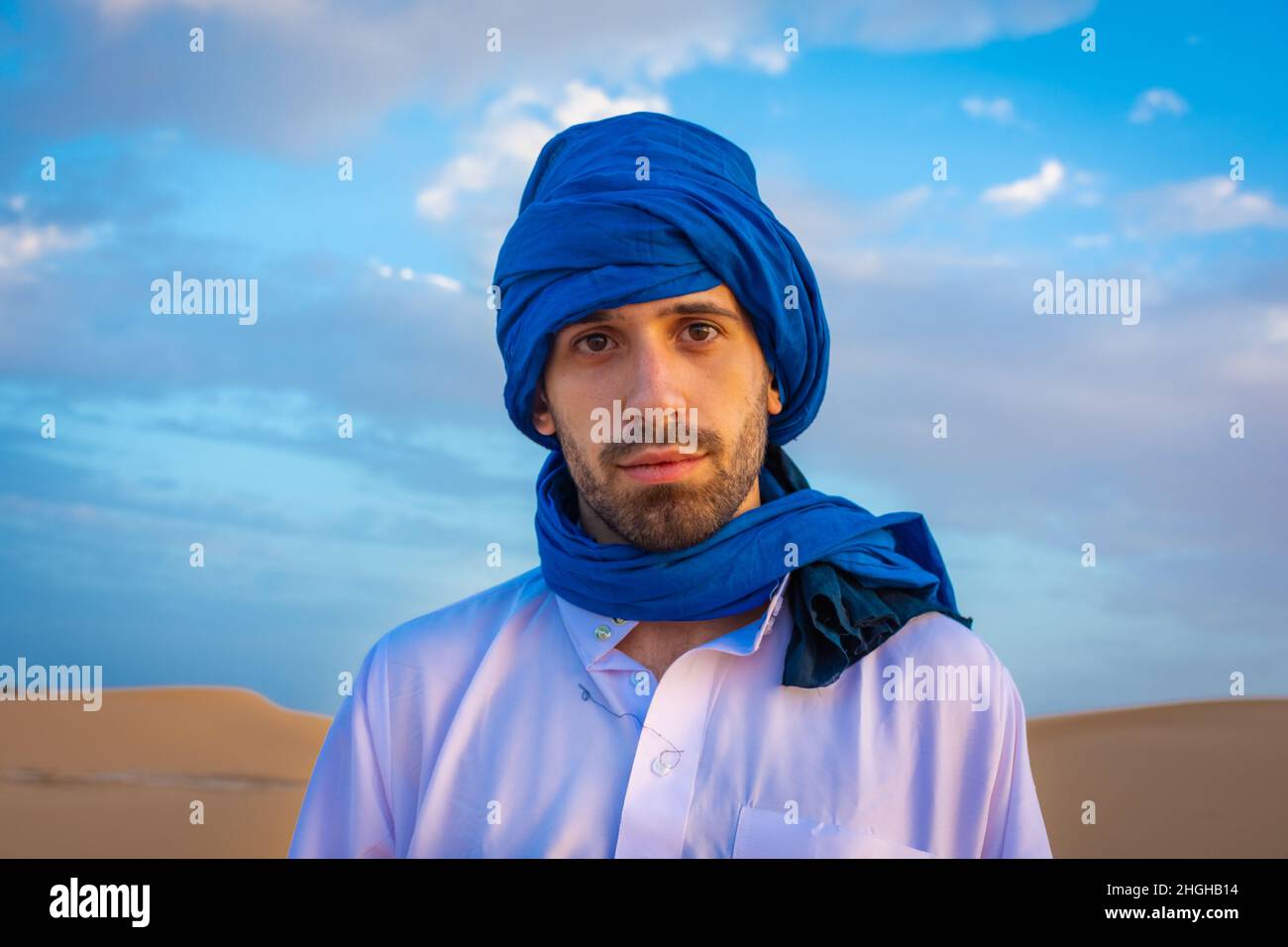 Young arabic man wearing traditional berber clothes in the Sahara ...