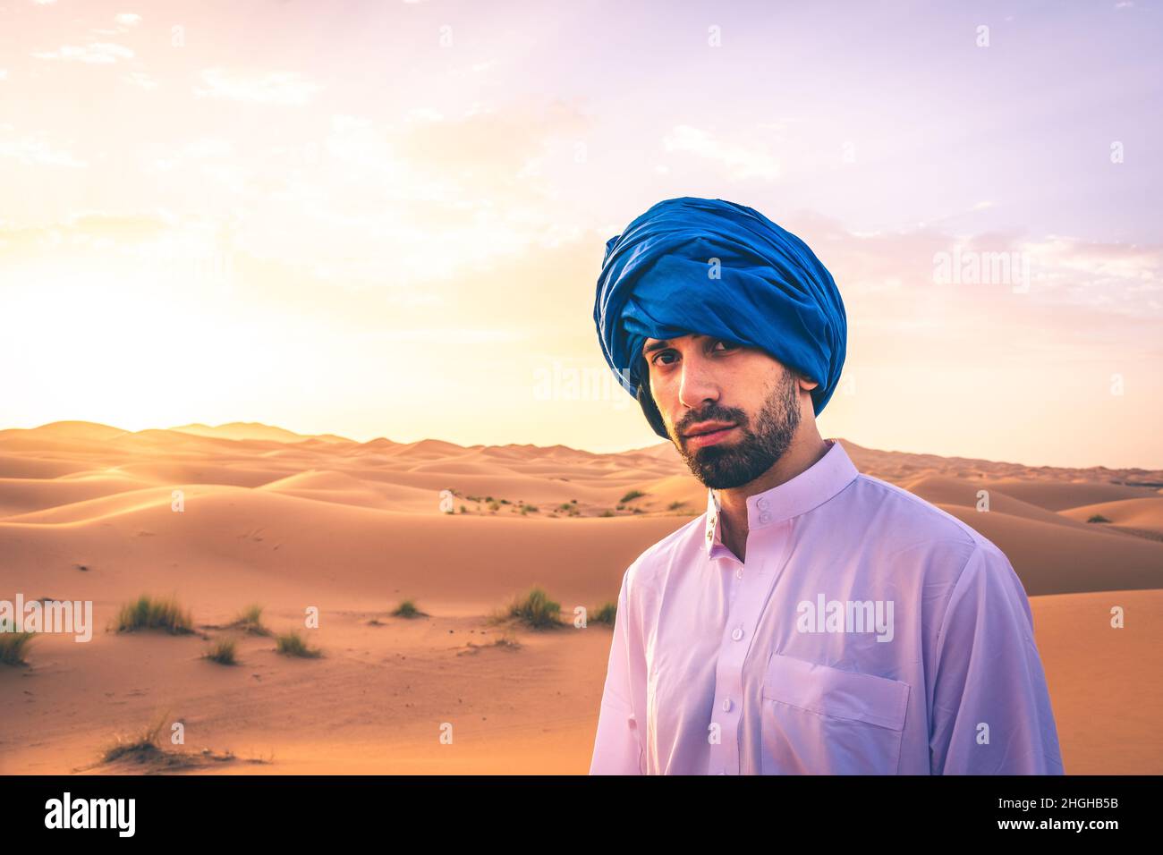 Young arabic man wearing traditional berber clothes in the Sahara ...