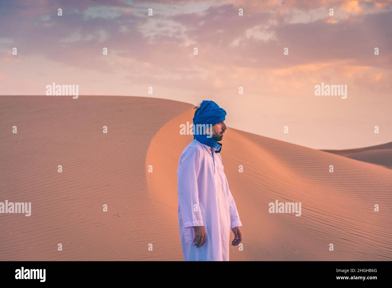 Young arabic man wearing traditional berber clothes in the Sahara ...