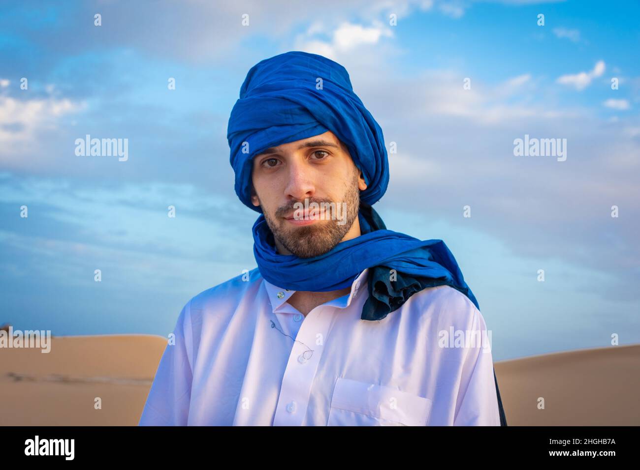 Young arabic man wearing traditional berber clothes in the Sahara ...