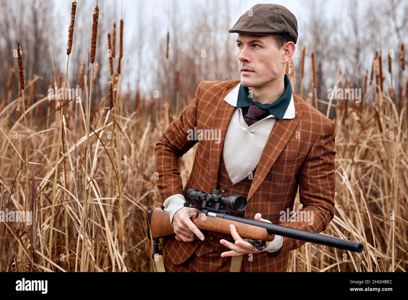 outdoor hunting on wild animals at autumn season. Man holding shotgun ...