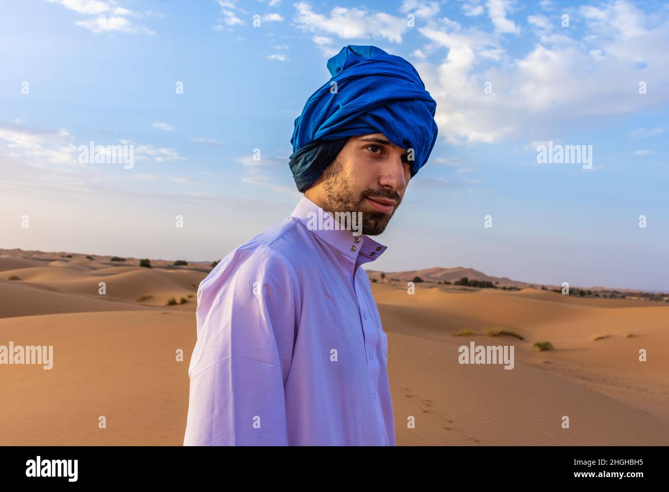 Young arabic man wearing traditional berber clothes in the Sahara ...