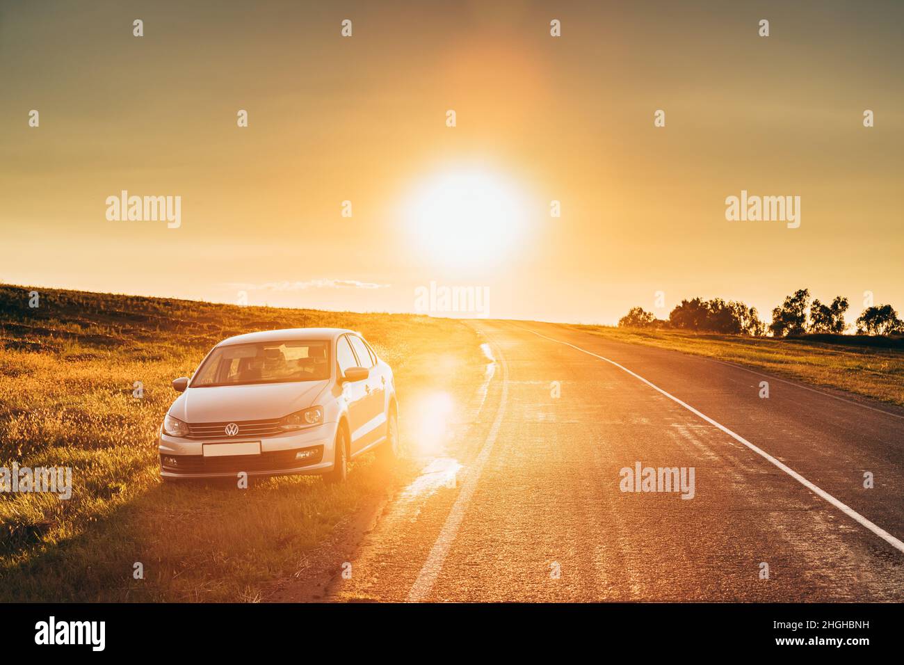 Sun Rising Over VW Volkswagen Polo Vento Sedan Car Parking Near Asphalt ...