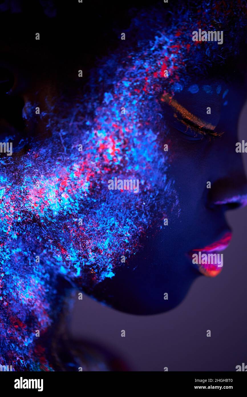 portrait of young black woman with colorful abstract make-up on face ...