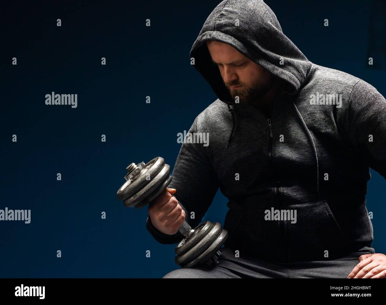 Healthy man hard workout of biceps in gym Stock Photo - Alamy