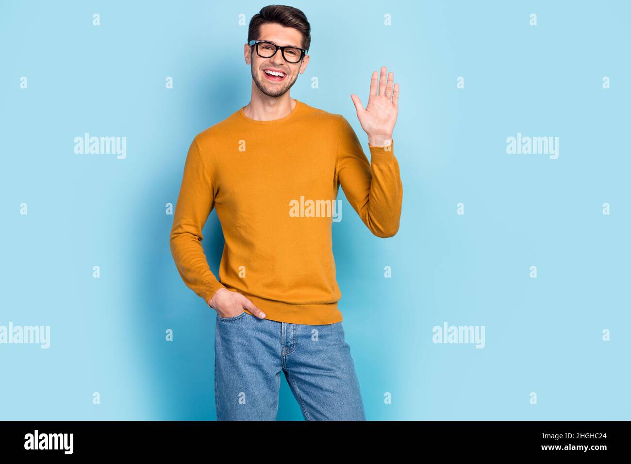 Photo of young cheerful man happy positive smile waving hand hello hi ...