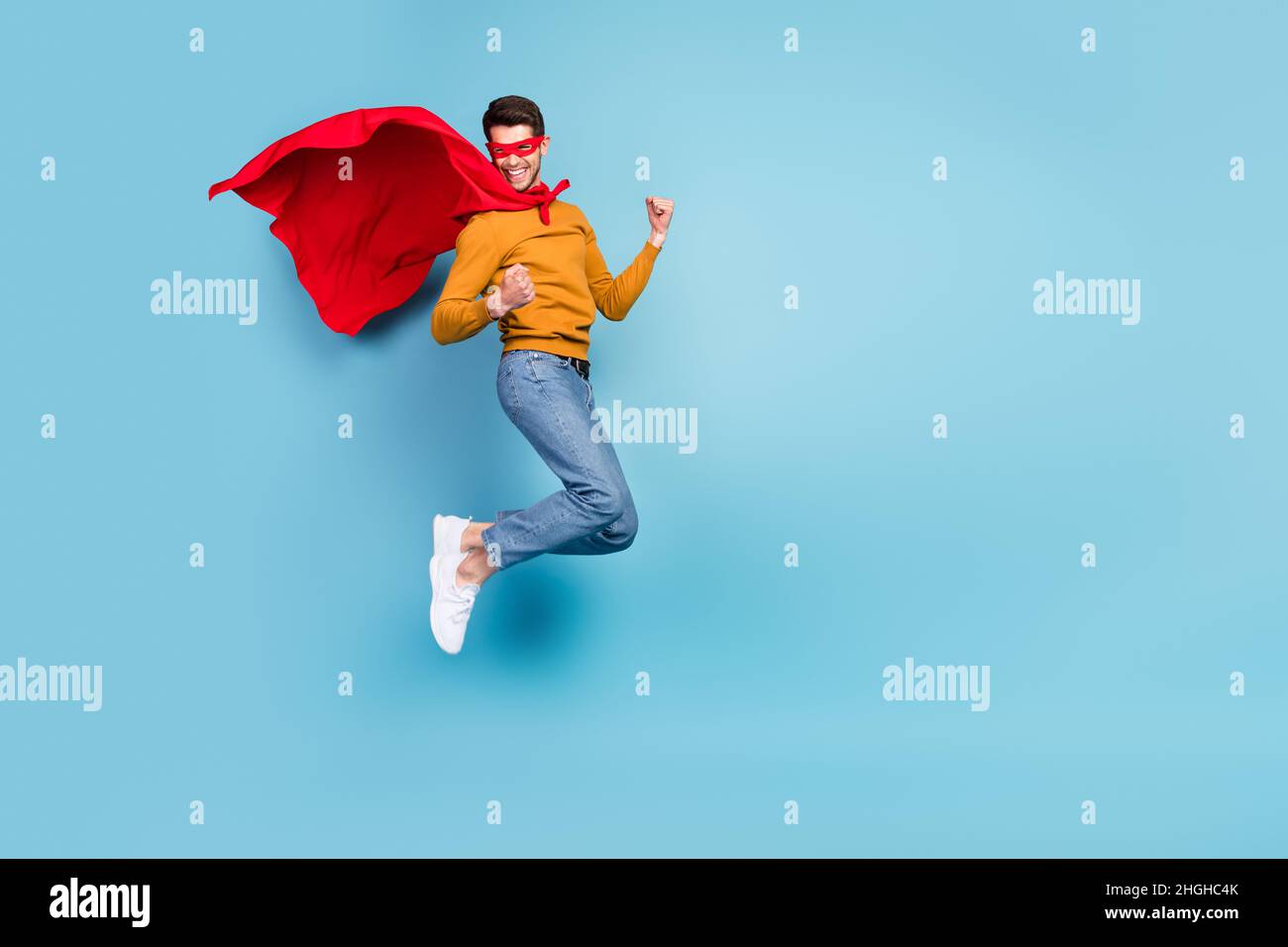 Photo of charming lucky guy dressed pullover superman costume jumping ...